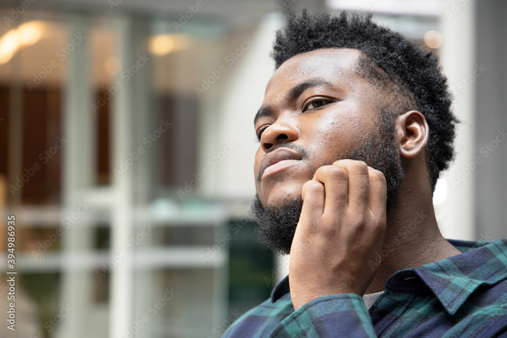 Man scratching suffering from itching facial skin; sick African man ...