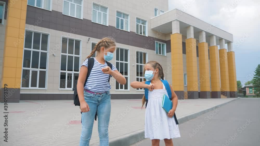Children go back to school. Elbow greeting girls at school. Children ...