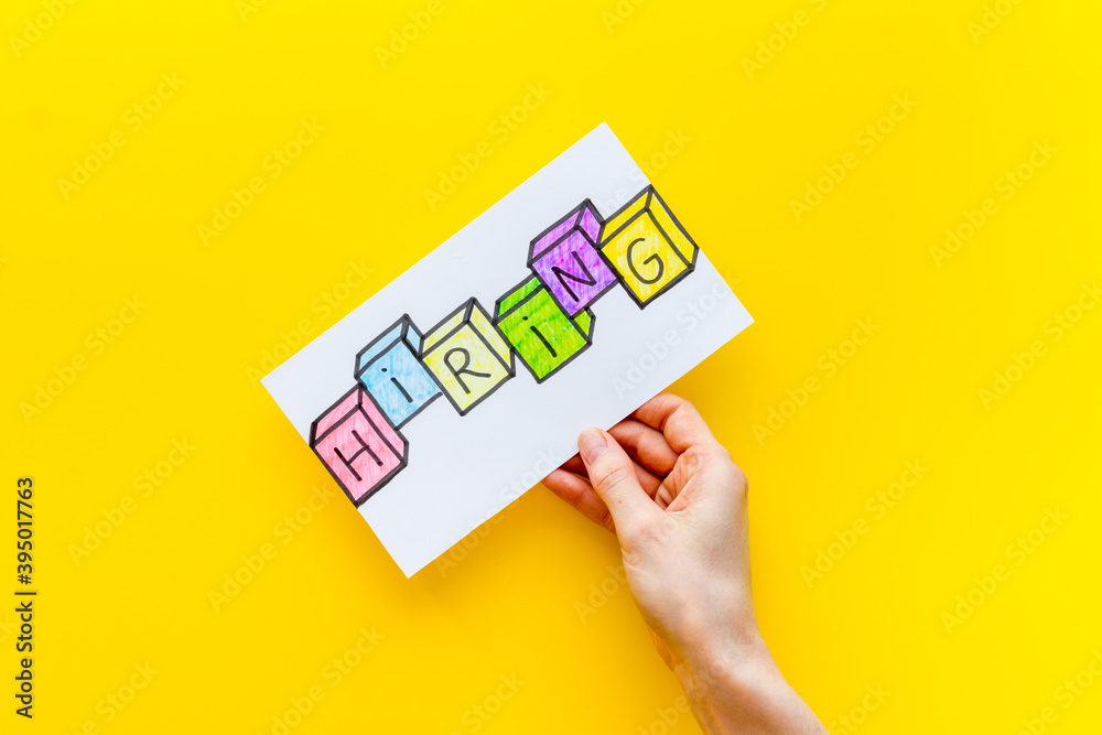 Hiring - job recruting concept. Word Hiring on paper banner, top view ...