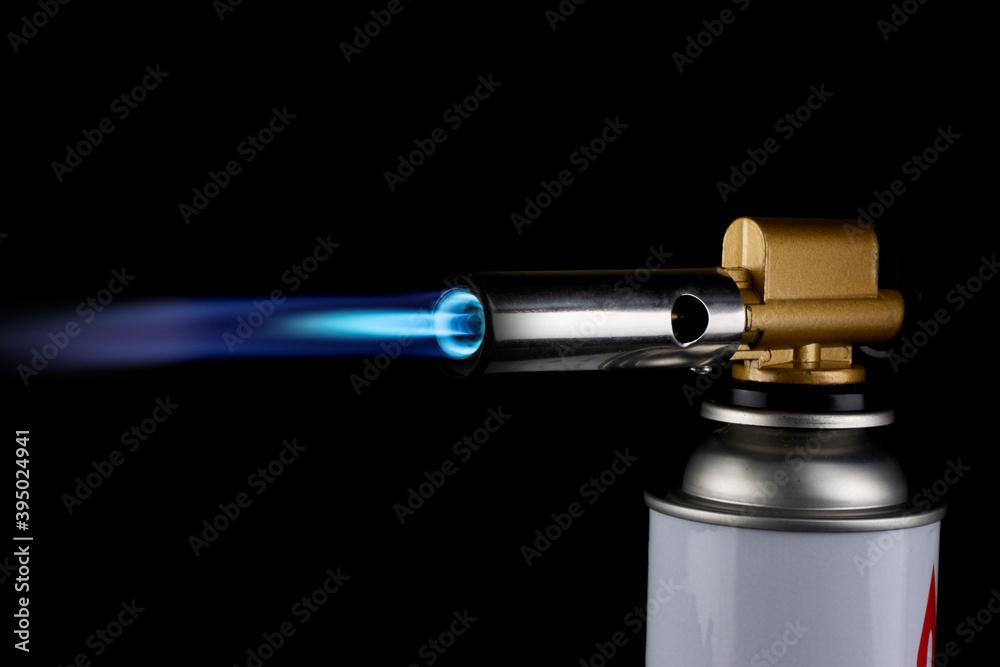 Flamethrower burner gas blow torch Ignition with blue fire flame at ...