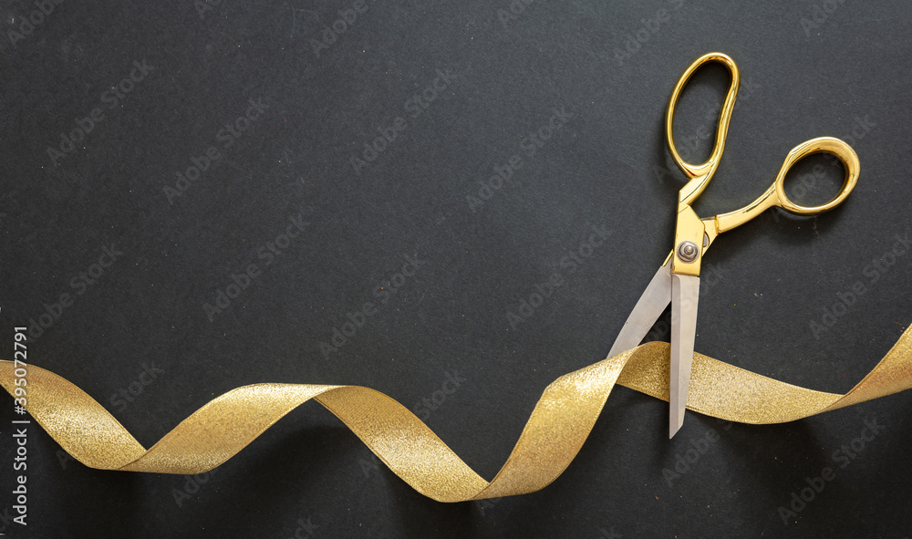 Grand opening. Gold scissors cutting gold satin ribbon, black ...