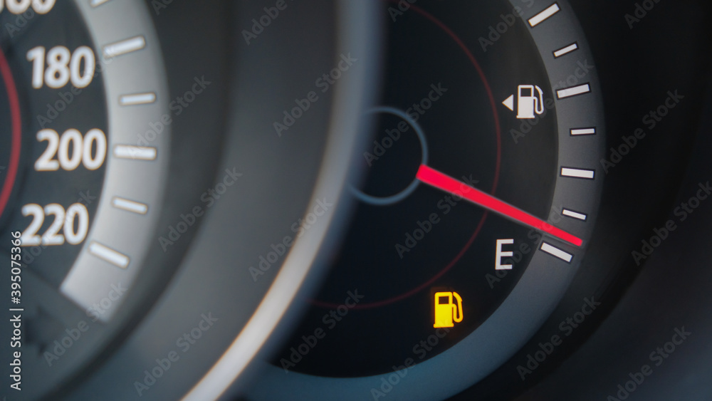 Fuel gauge with warning indicating low fuel tank foto de Stock | Adobe ...