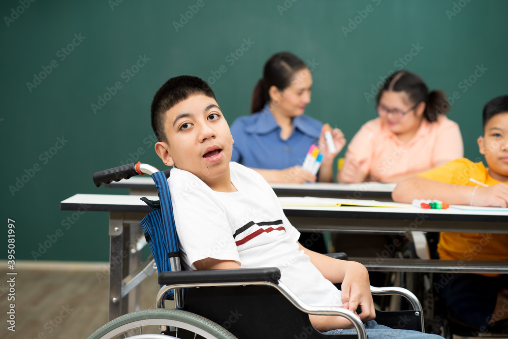 disability boy sitting on wheelchair in classroom special with teacher ...