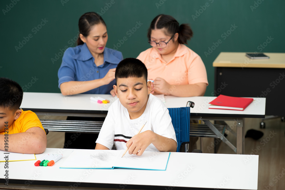 disability boy sitting on wheelchair in classroom special with teacher ...