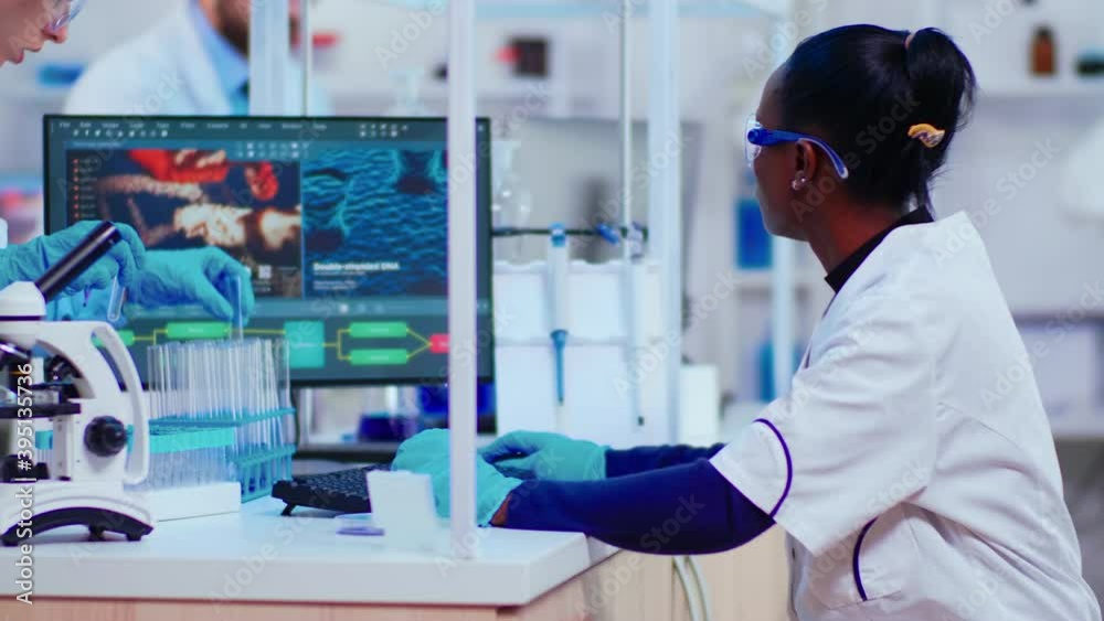 African woman biochemist researcher checking manifestations of vaccine ...
