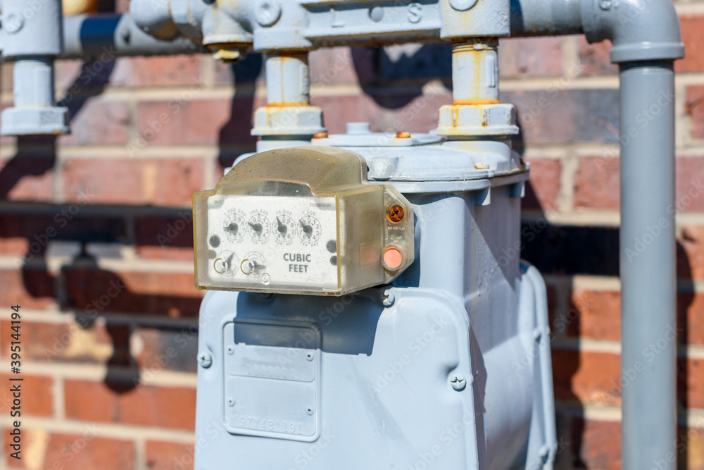 Gas meter with pipes on a brick wall Stock Photo | Adobe Stock