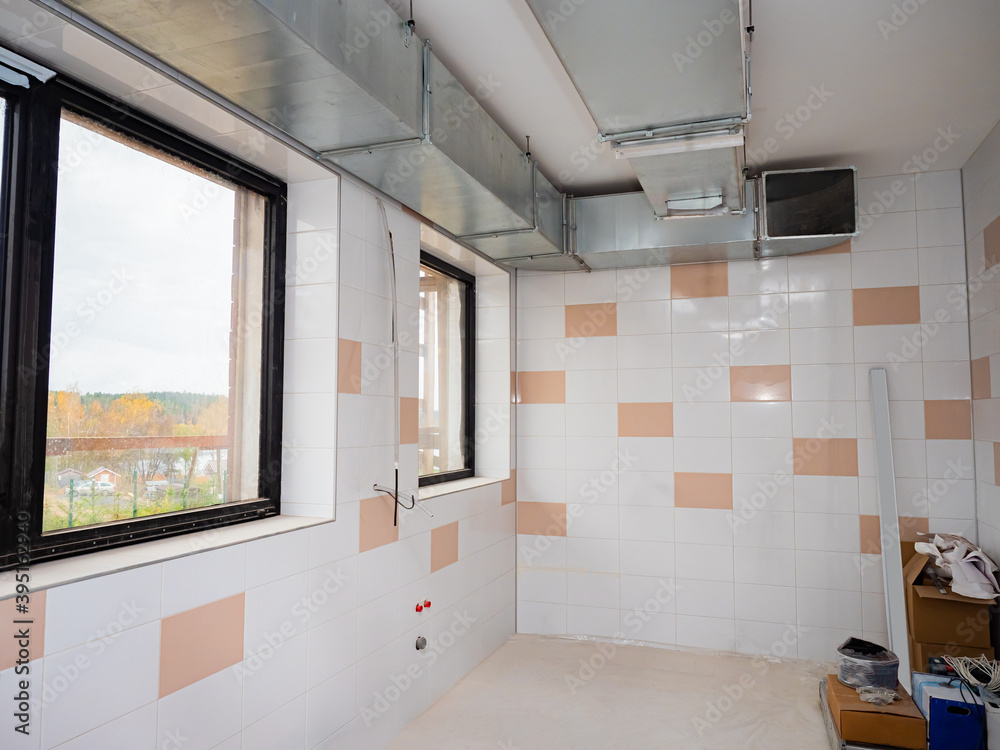 Installation of ventilation in the utility room. The room is tiled and ...