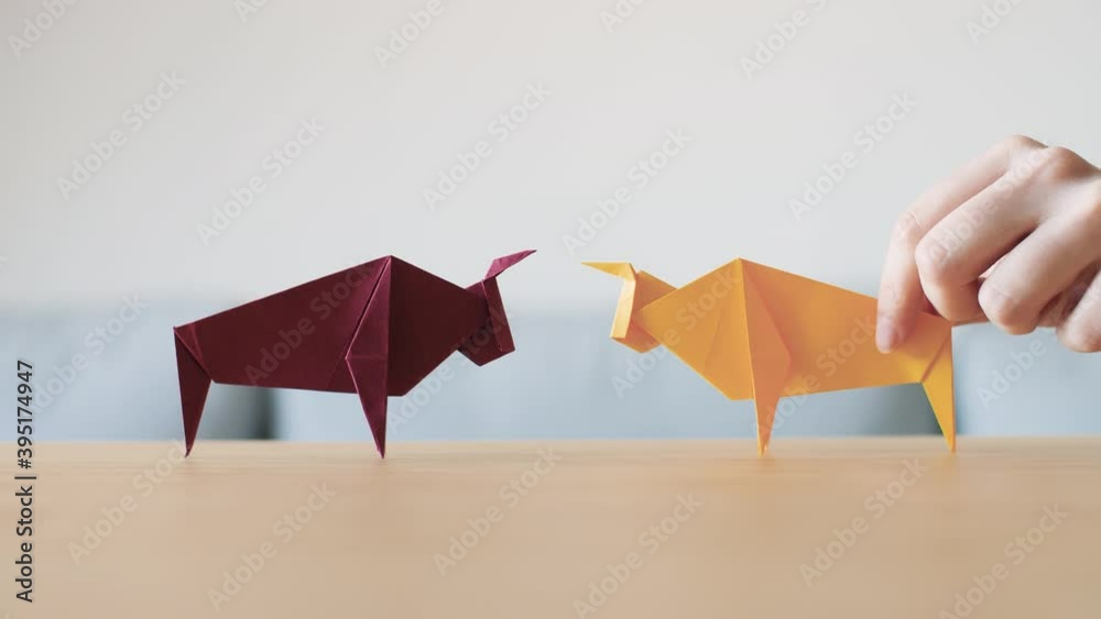 A red and yellow Origami Ox meet on table. Symbol for a happy Chinese ...