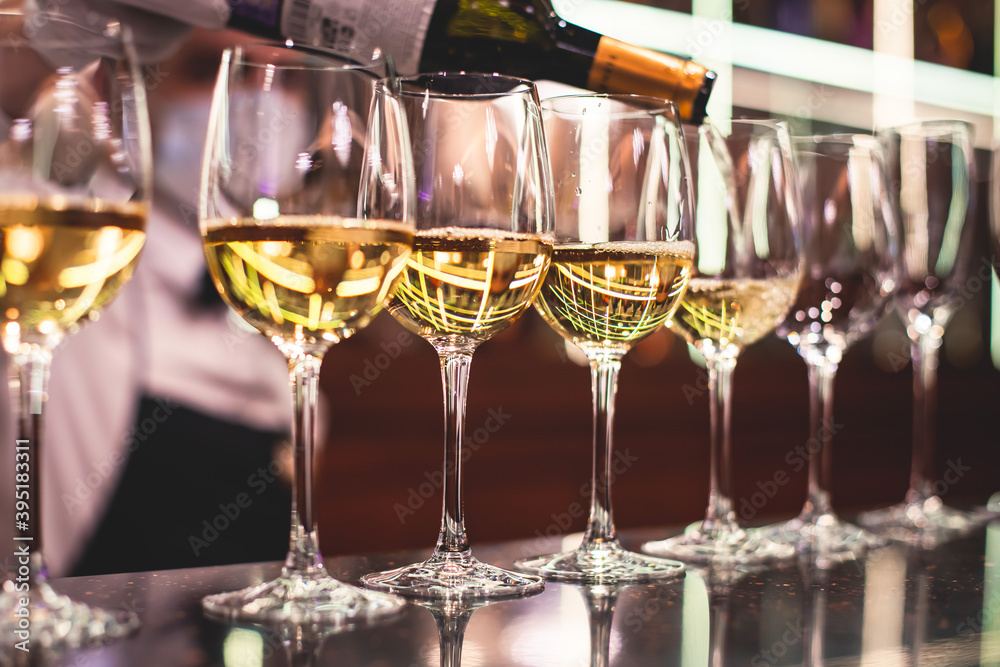 Line of alcohol setting on catering banquet table, bartender pouring ...
