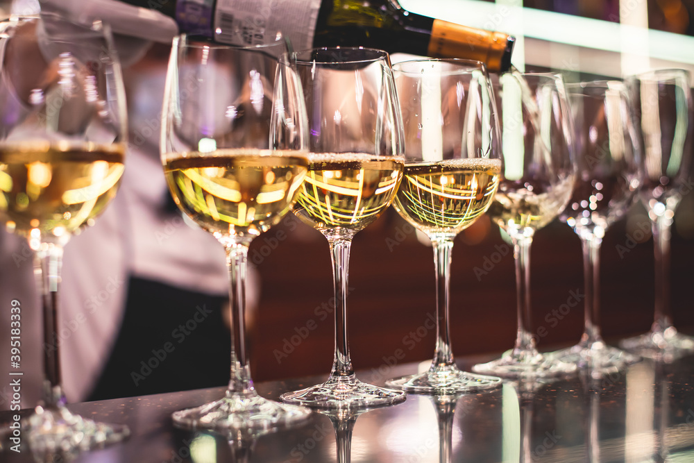 Line of alcohol setting on catering banquet table, bartender pouring ...
