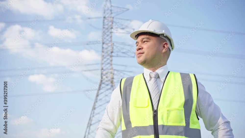 Vision of engineer. Smiling asian electrical engineer looking at camera ...
