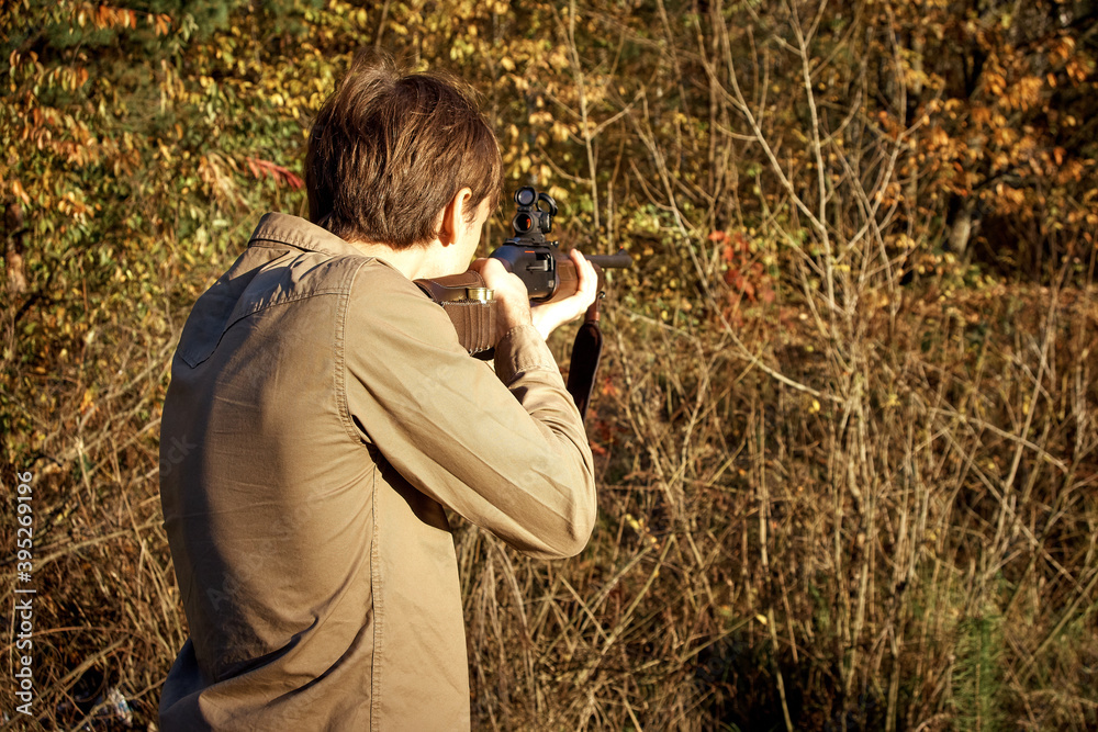 Hunter hunting in the forest with a hunting rifle. A man with a gun ...