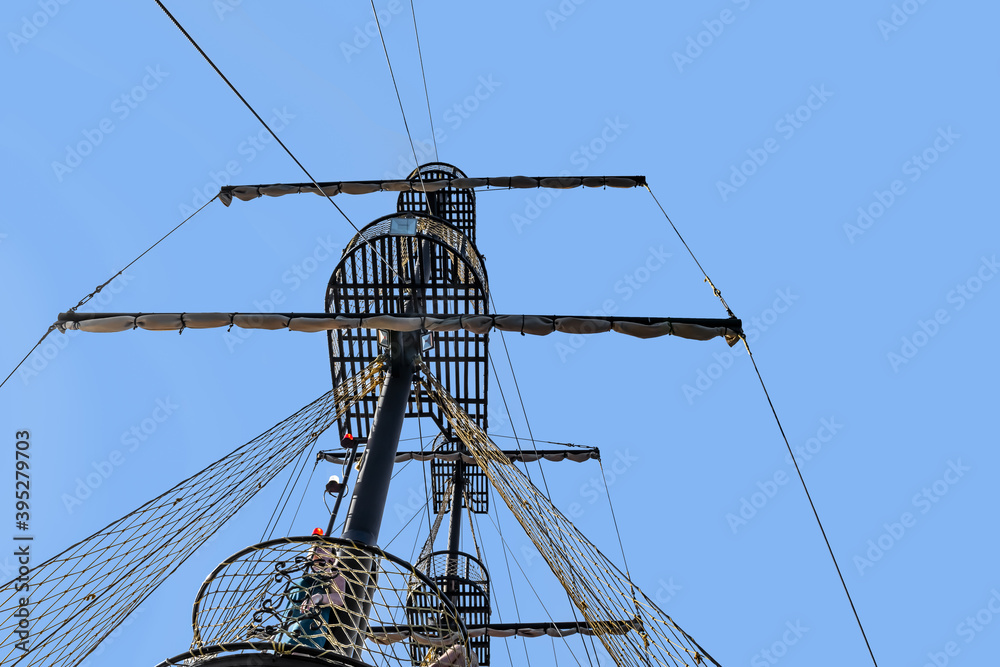 Vintage ship mast isolated on blue sky background - bottom view. Spar ...