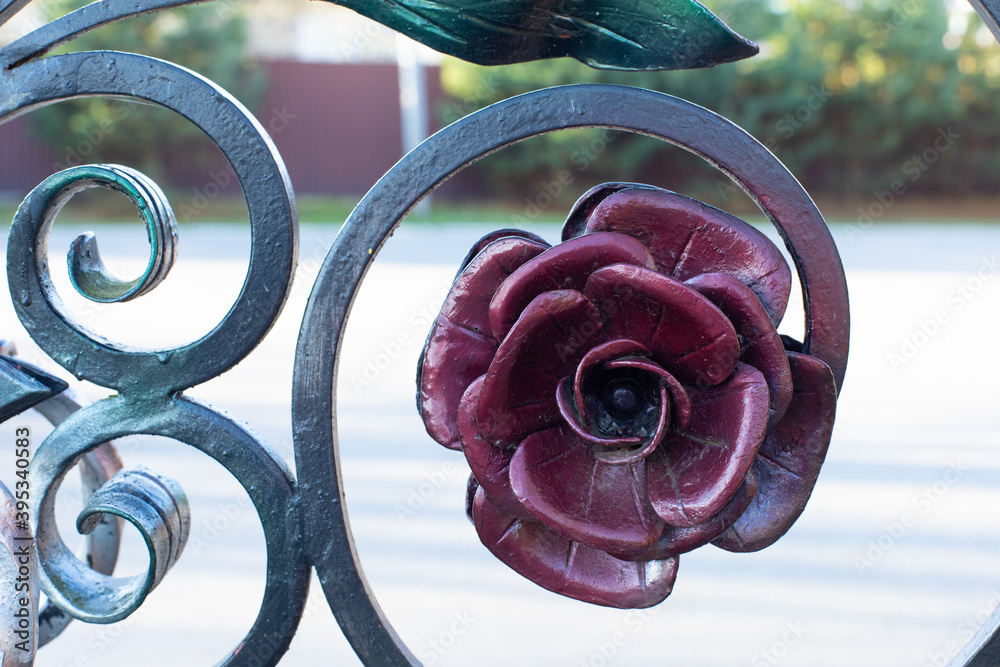 Metal flower in the design of a forged gate close-up, an iron flower ...