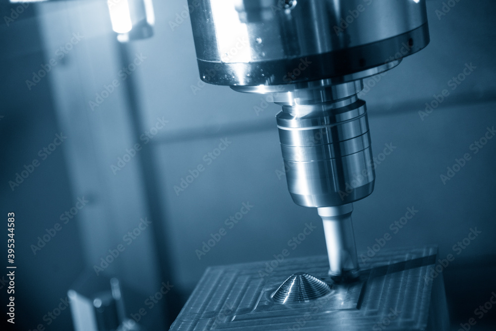 The CNC milling machine rough cutting the injection mold parts by ...