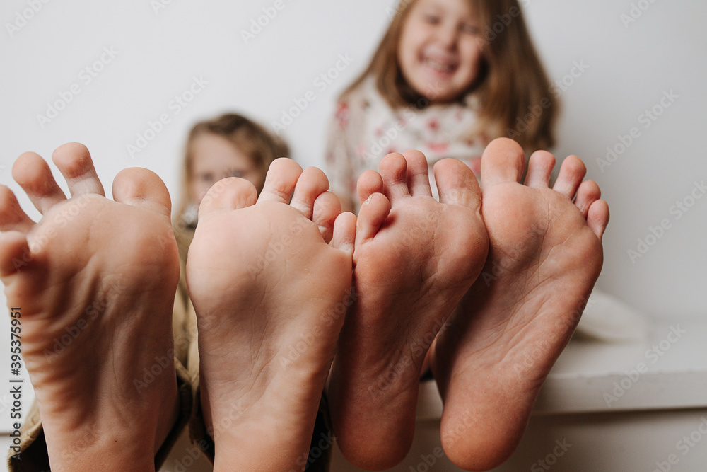 Children's bare feet close up to the camera. Their blurred giggling ...