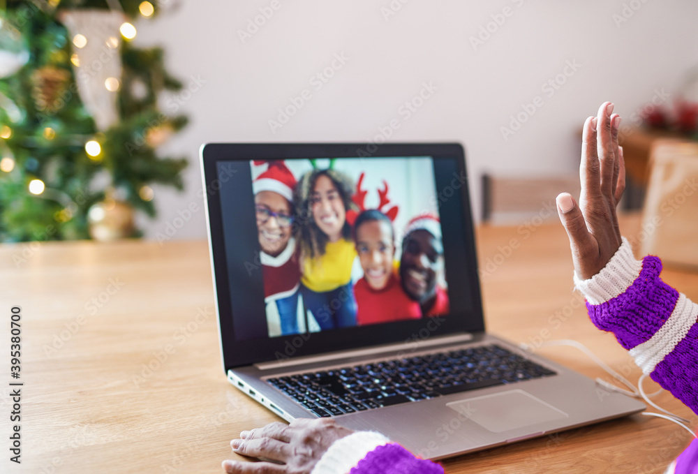 African woman on a video call with family for christmas day - Concept ...