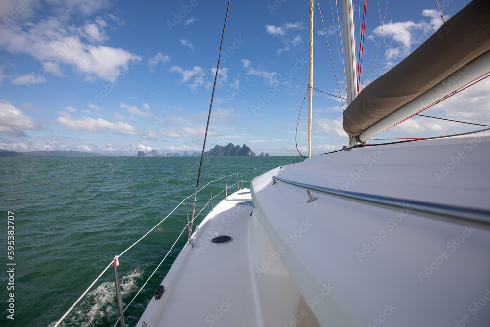 View of the blue sea water from the side of a sailboat with rigging and ...