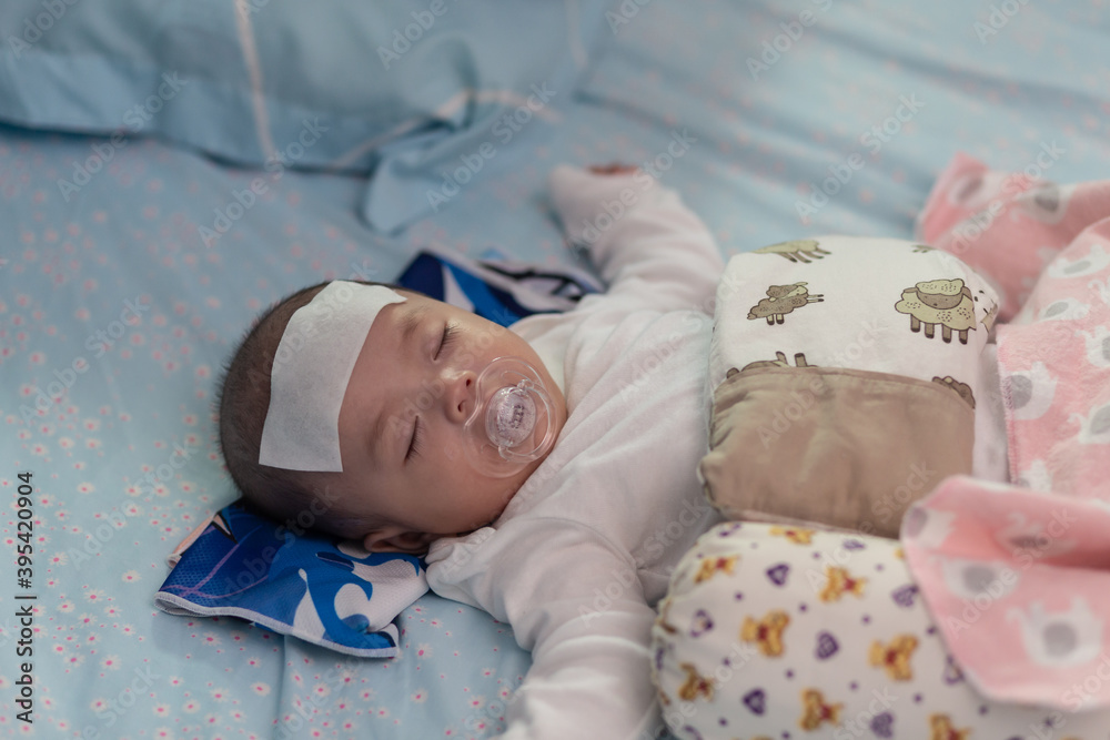 Asian Chinese baby sleeping during high fever with cool fever jel pad ...