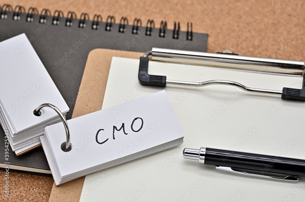 On top of the notebook and clipboard is a wordbook and pen with the ...