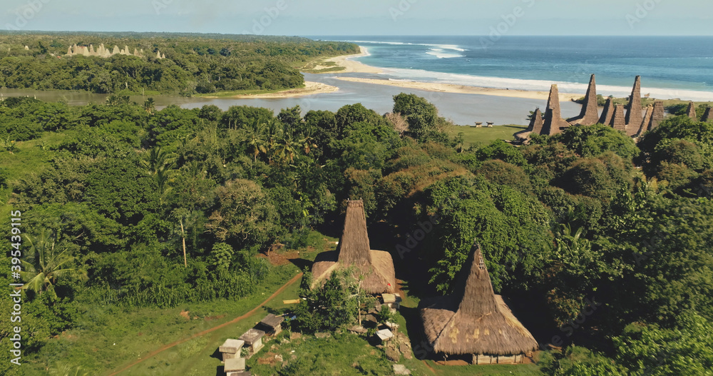 Indonesia long-held tradition village with ornate roof at sand beach ...