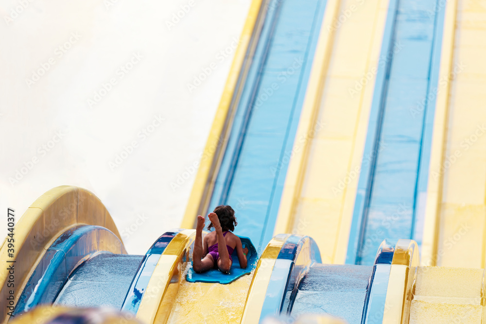 Cool people having fun on the water slide with friends and familiy in ...