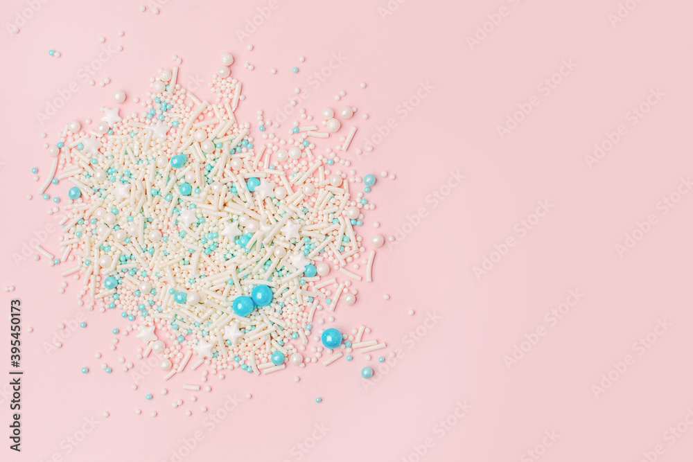 Festive border frame of colorful pastel sprinkles on pink background ...