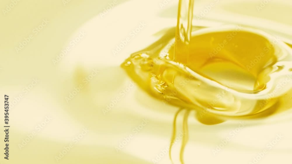 Close-up pouring golden olive oil liquid in slow motion, healthy food ...