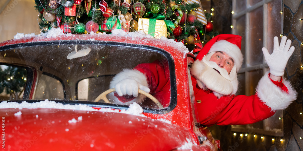 Santa claus greeting while driving a red retro car. Merry Christmas ...