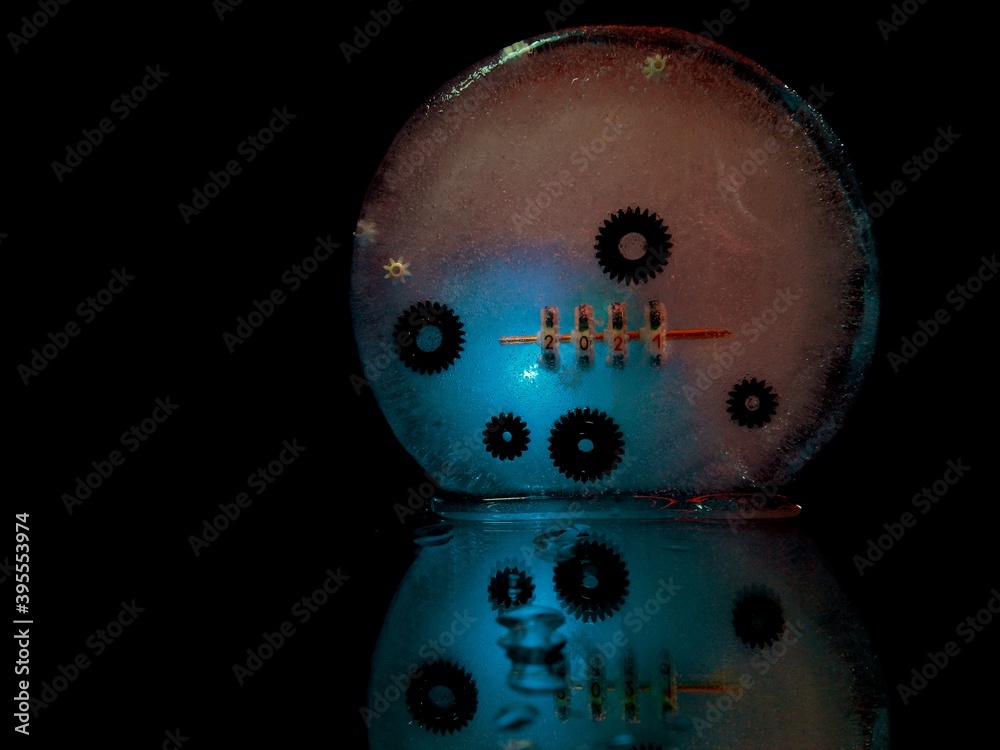 abstract and creative photo of gears frozen in ice and a counter ...