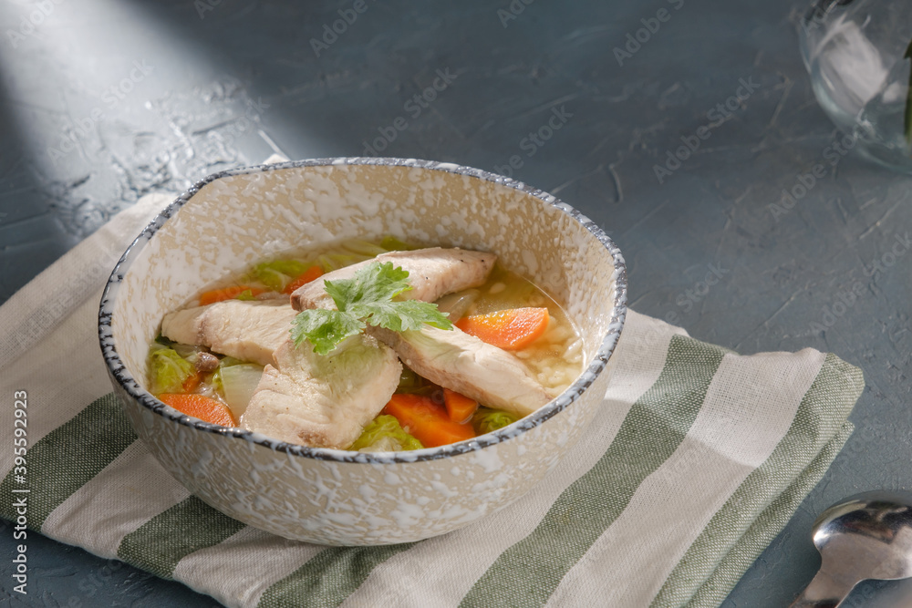 Snakehead fish porridge topped with coriander in a bowl on gray table ...