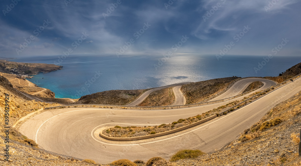 Breathtakingly steep and curvy roads climbing the coastal cliffs of the ...