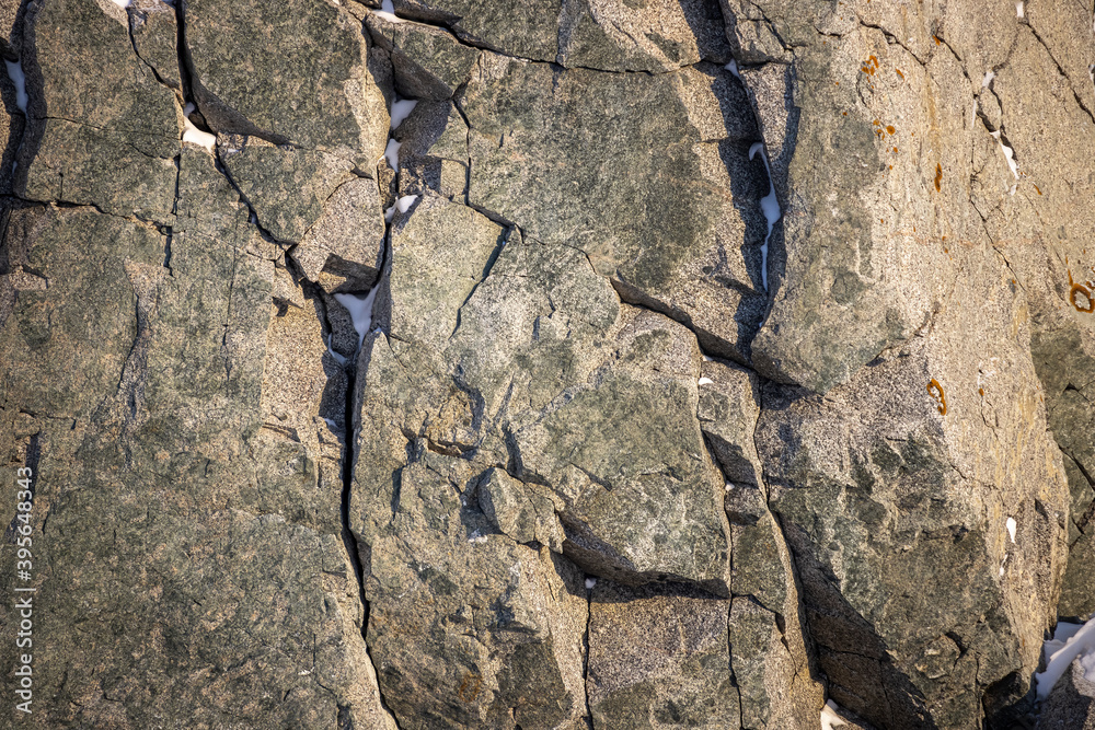 Rock texture. Snow and cracks on the surface of the cliff. Natural ...