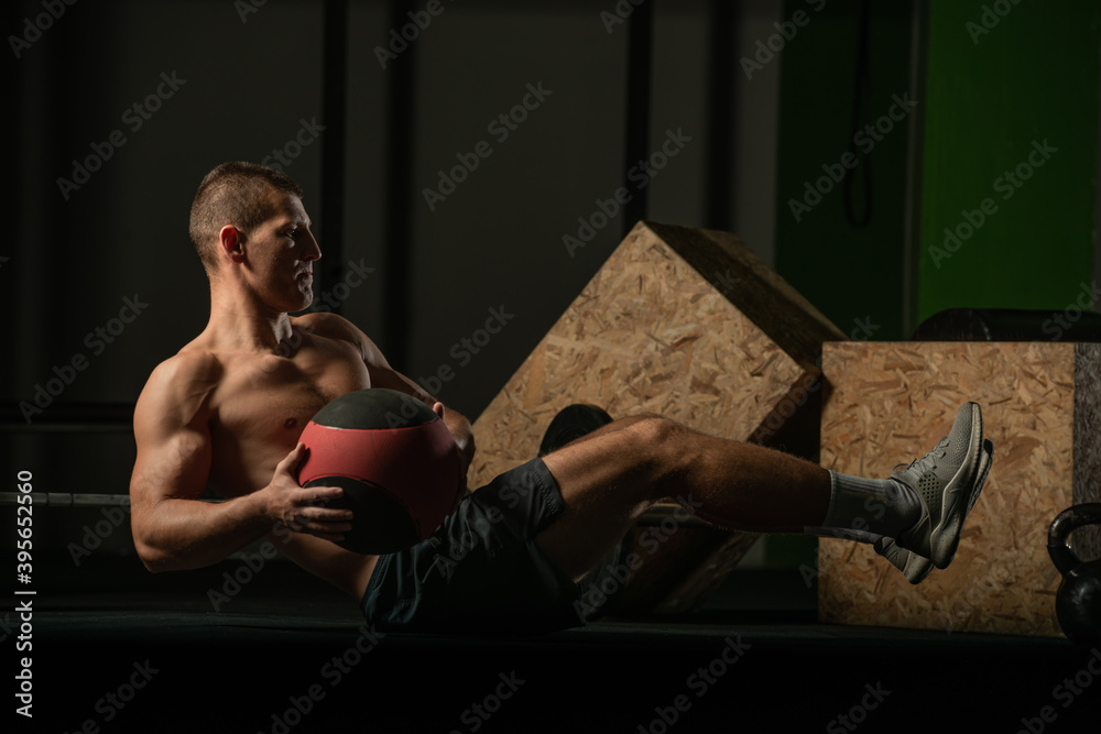 Shirtless pro athlete doing russian twist abs workout. Close up photo ...