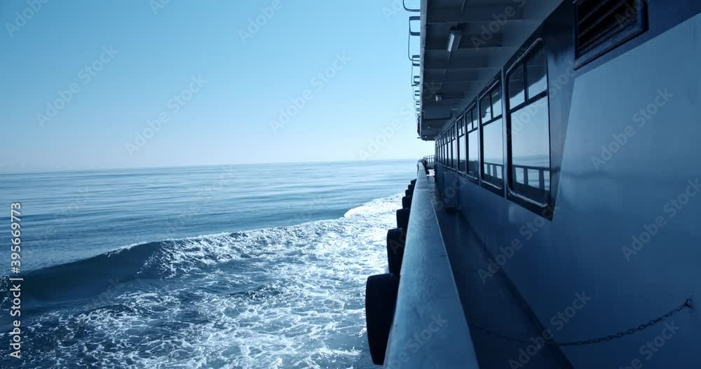 on the side of a boat, looking toward the horizon. the waves crack ...