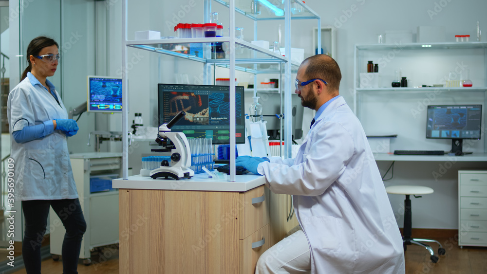 Scientist working in modern equipped laboratory cheching virus ...