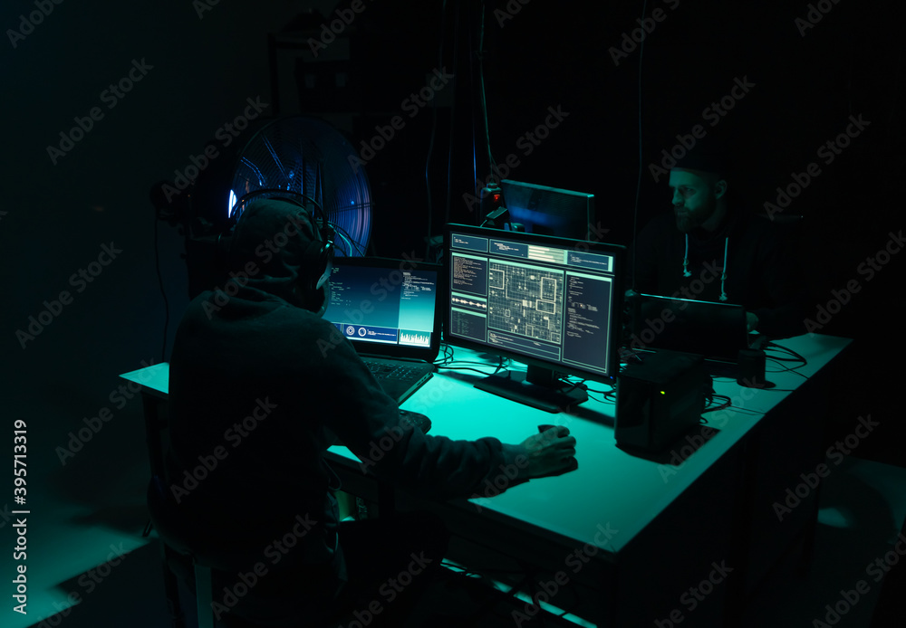 Wanted hackers coding virus ransomware using laptops and computers. Cyber attack, system ...