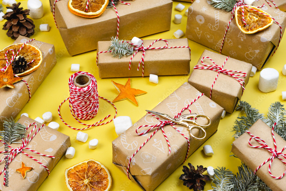 Many eco gift boxes on yellow background. Christmas season holiday ...