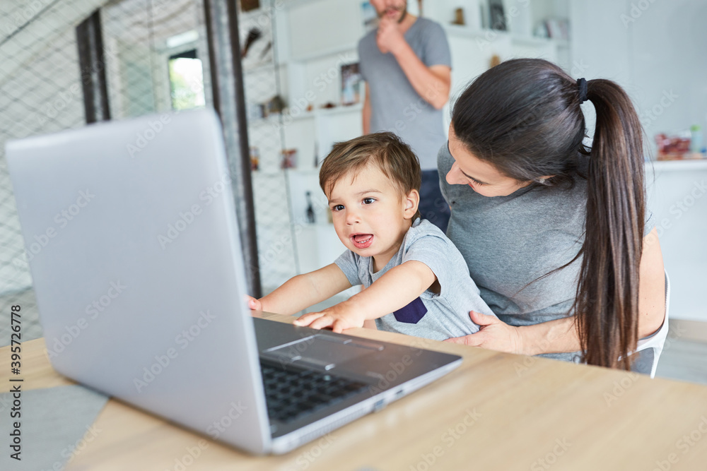 Toddler playing on laptop computer in living room Stock Photo | Adobe Stock