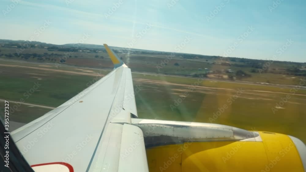 View from inside passenger airplane window on landing strip and plane ...