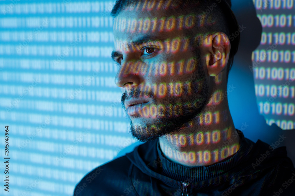 Portrait of hacker man on blue neon light digital interface background ...
