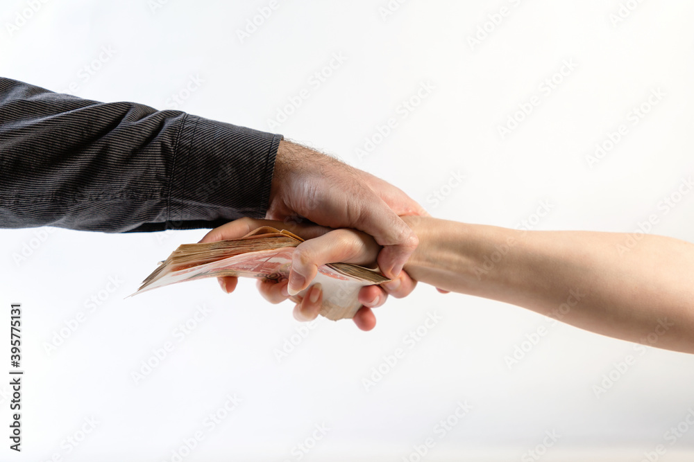 Anti-Bribery. A male's hand in a black shirt grabs a female's hand with ...