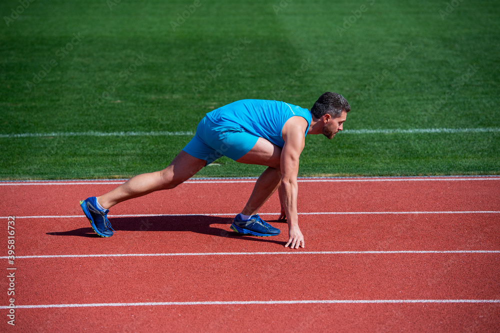 energy. muscular guy start to run. man running on stadium. sports and ...