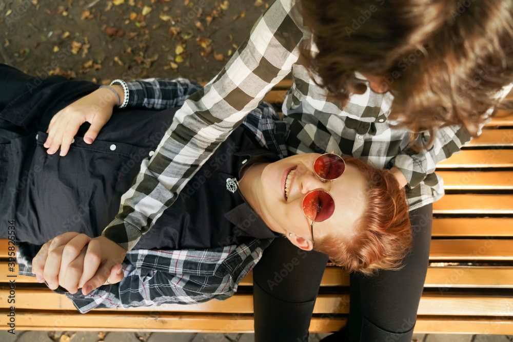 Stylish young couple is spending time together outdoors. Top view of ...