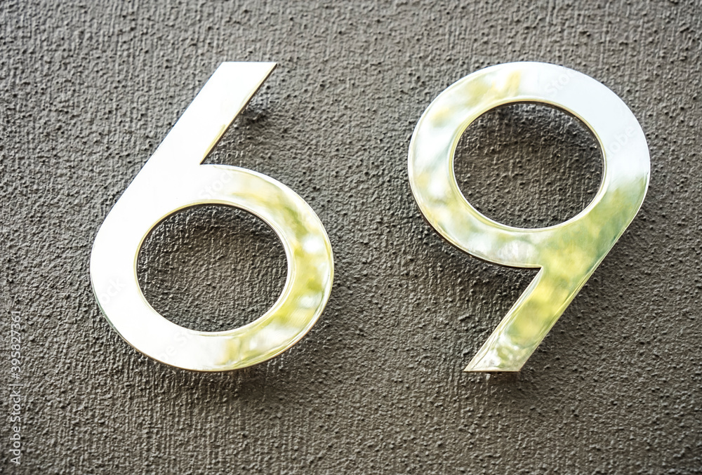 golden number 69 sixty nine isolated on black wall texture. stone ...