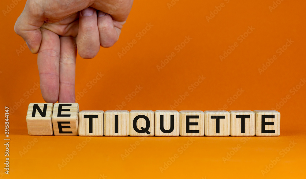 Etiquette or netiquette. Male hand turns cubes and changes the word ...