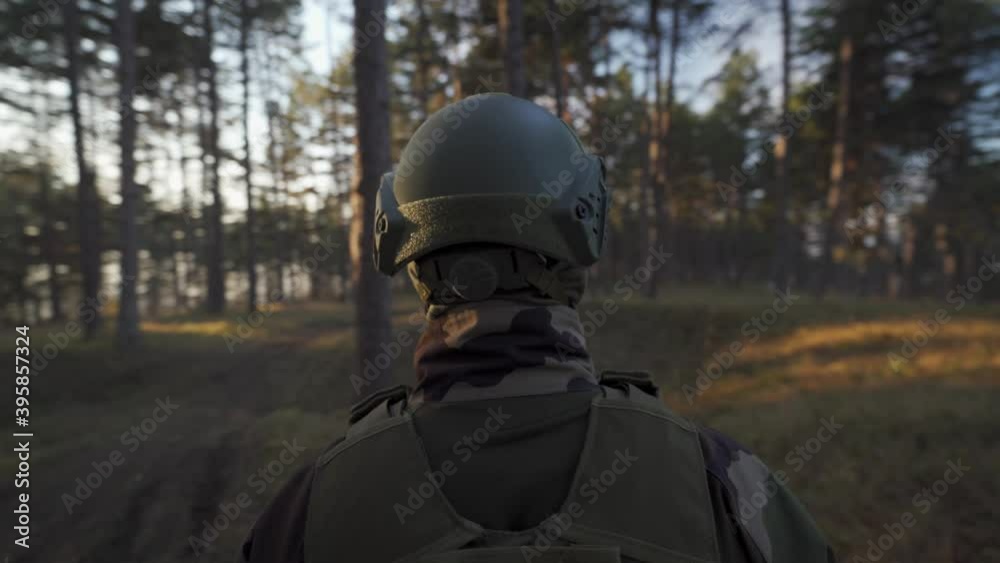 one man front view portrait of soldier in camouflage uniform armed with ...