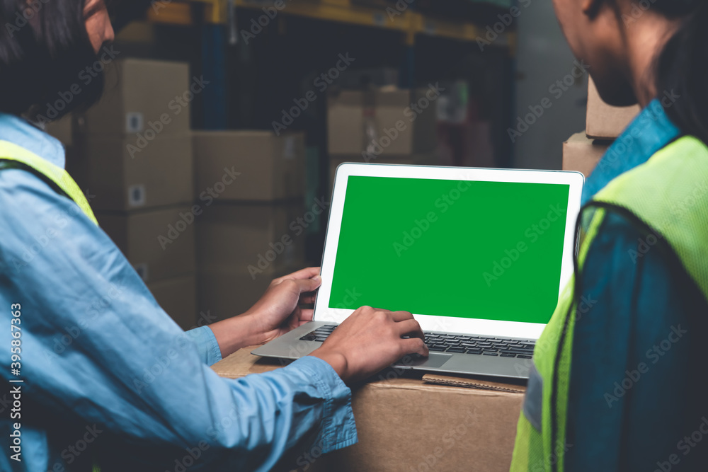 Computer with green screen display in warehouse storage room . Delivery ...