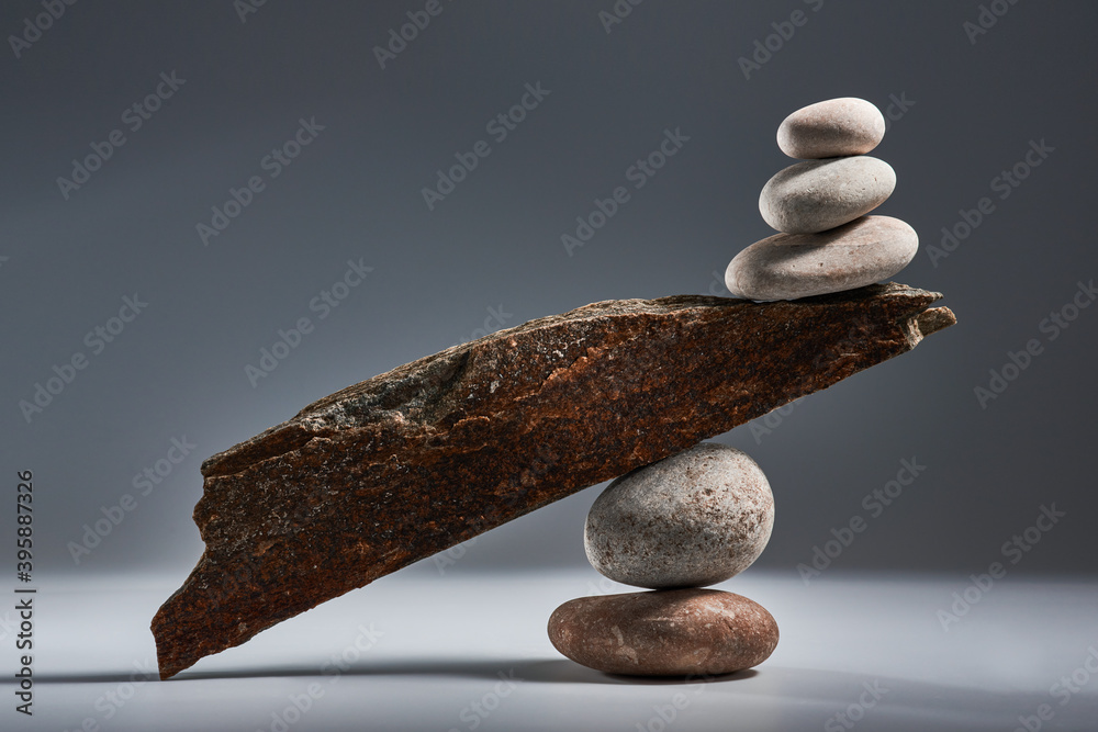 Balancing pyramid of sea pebbles on a gray background, the concept of ...