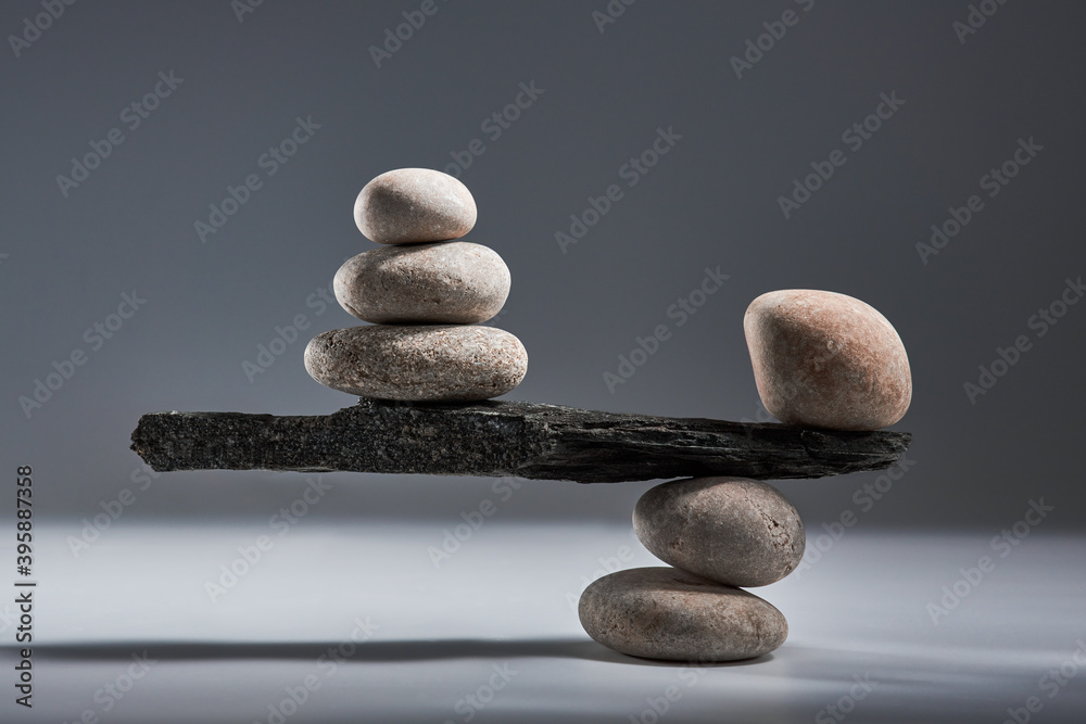 Balancing pyramid of sea pebbles on a gray background, the concept of ...